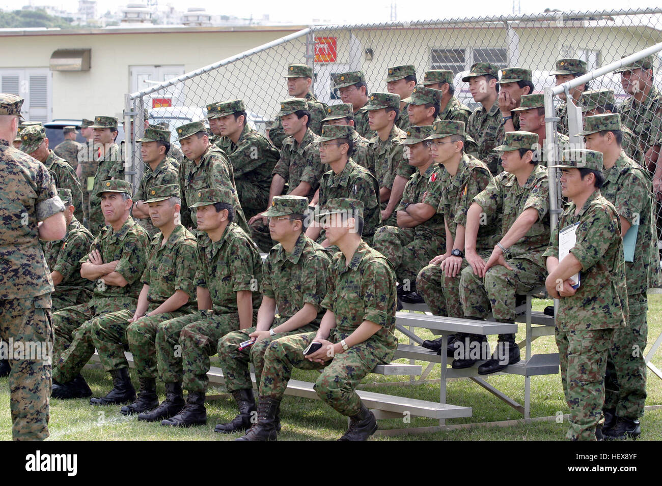 Japanese Ground Self Defense Force (JGSDF) soldiers, seated on bleacher ...