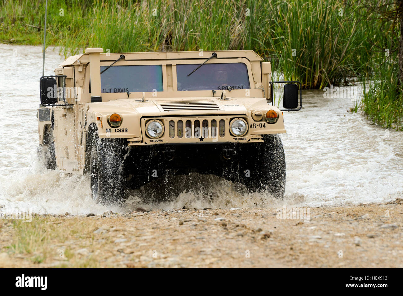 A U.S. Army Humvee goes through the water during convoy training ...
