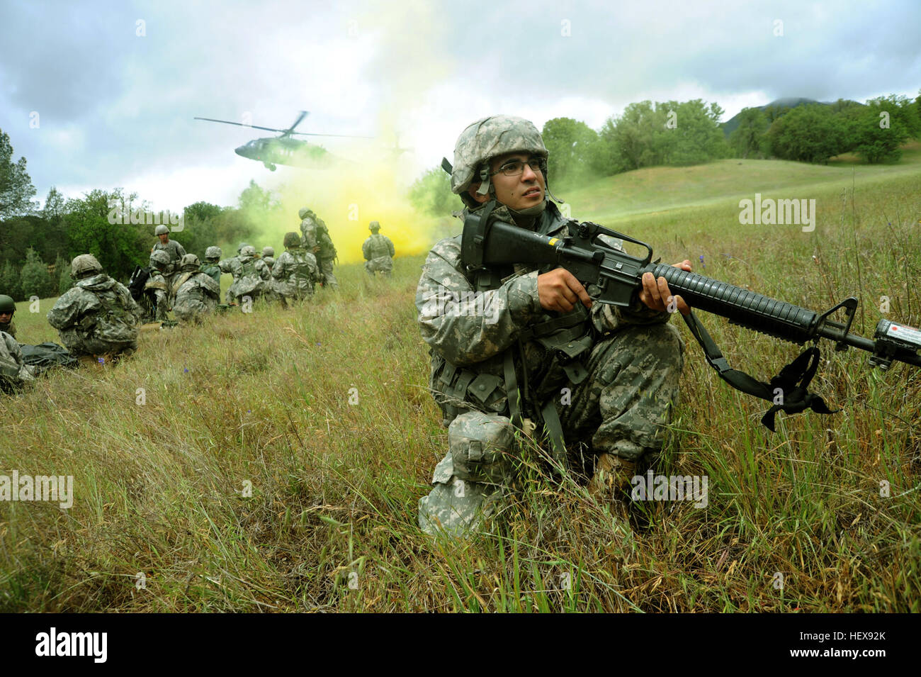 U.S. Army Soldiers pop yellow smoke and pull security during an ...