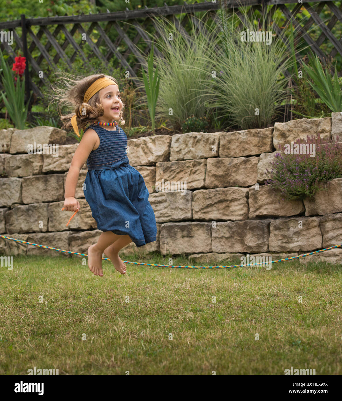 Girl playing with skipping rope hi-res stock photography and images - Alamy