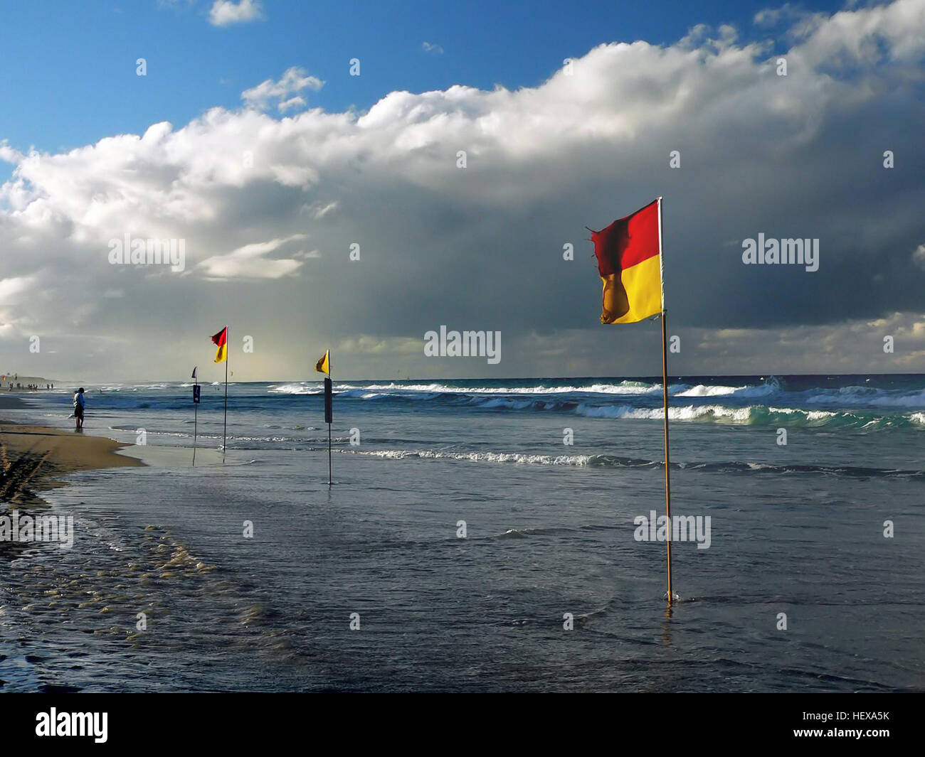 This image depicts an Australian beach scene featuring a lifeguard and ...