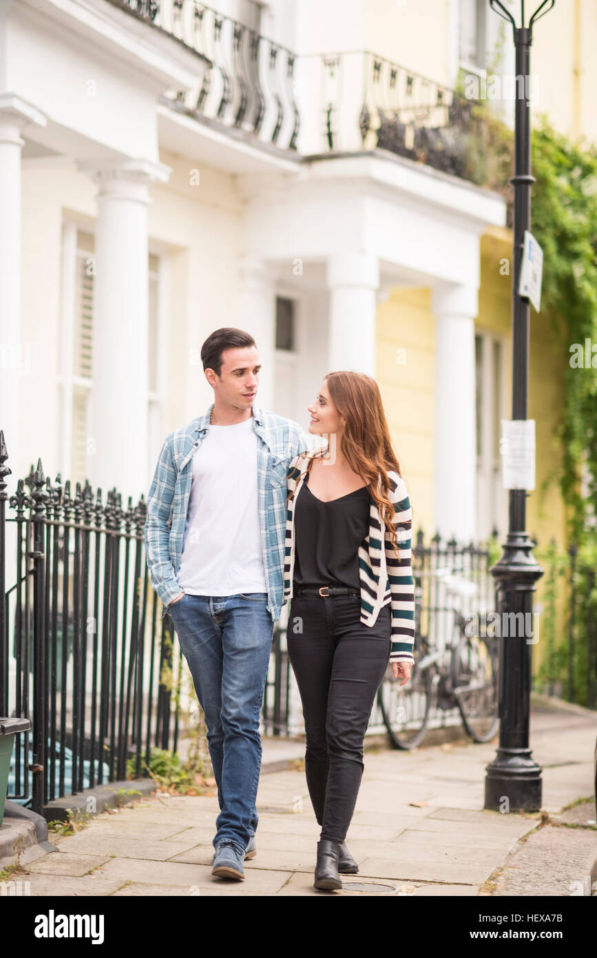 Smiling walking face to face arm around hi-res stock photography and ...