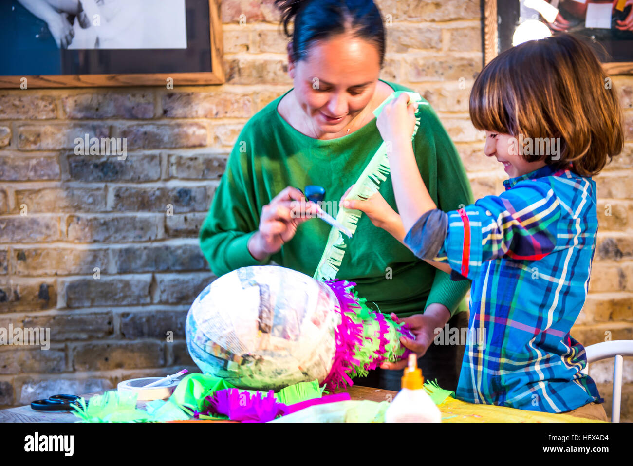 Mother and son decorating pinata at home Stock Photo - Alamy