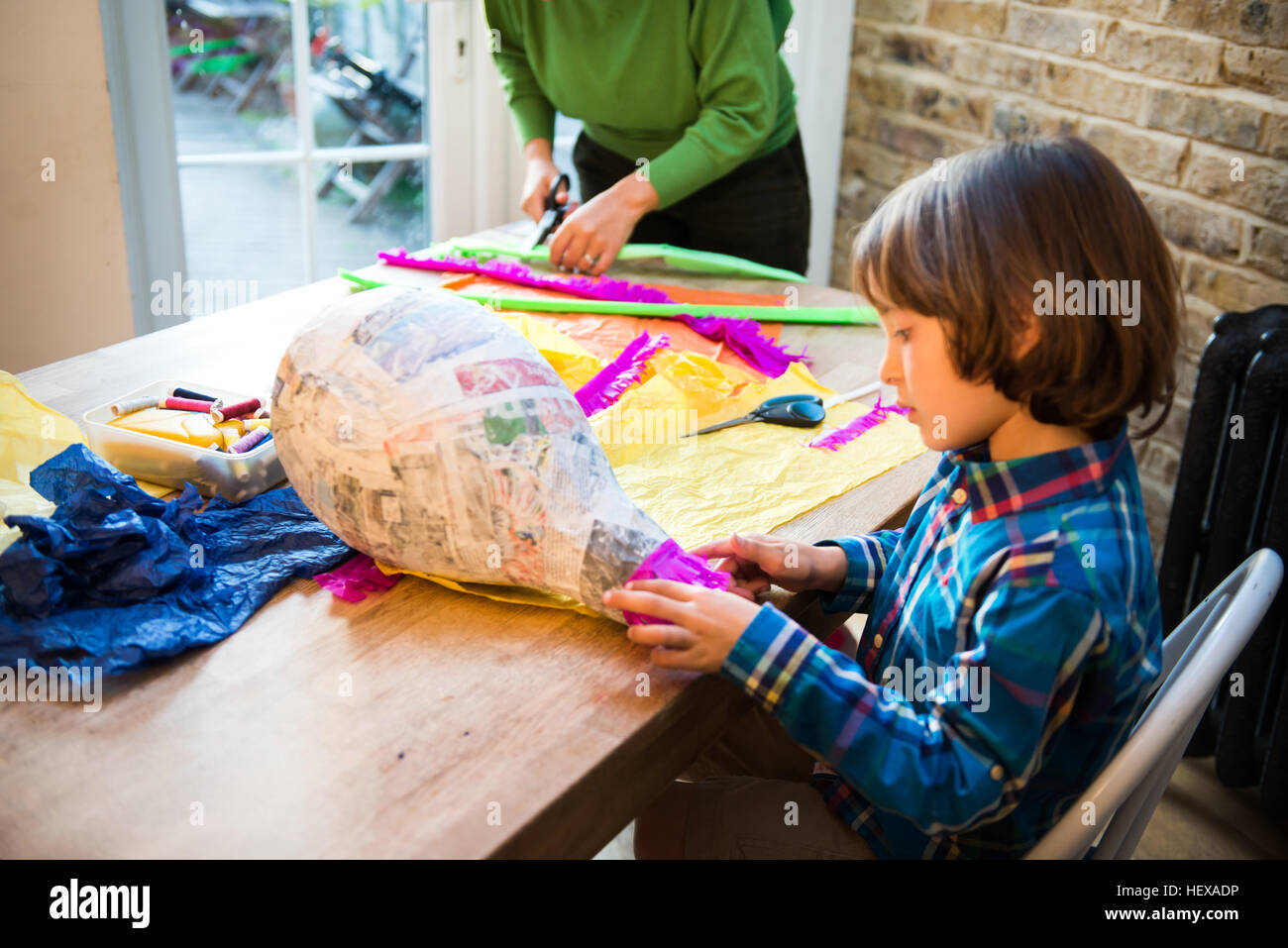 Mother and son decorating pinata at home Stock Photo - Alamy