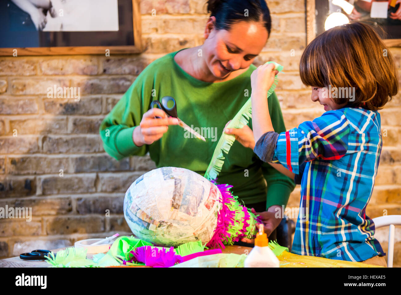 Mother and son decorating pinata at home Stock Photo - Alamy