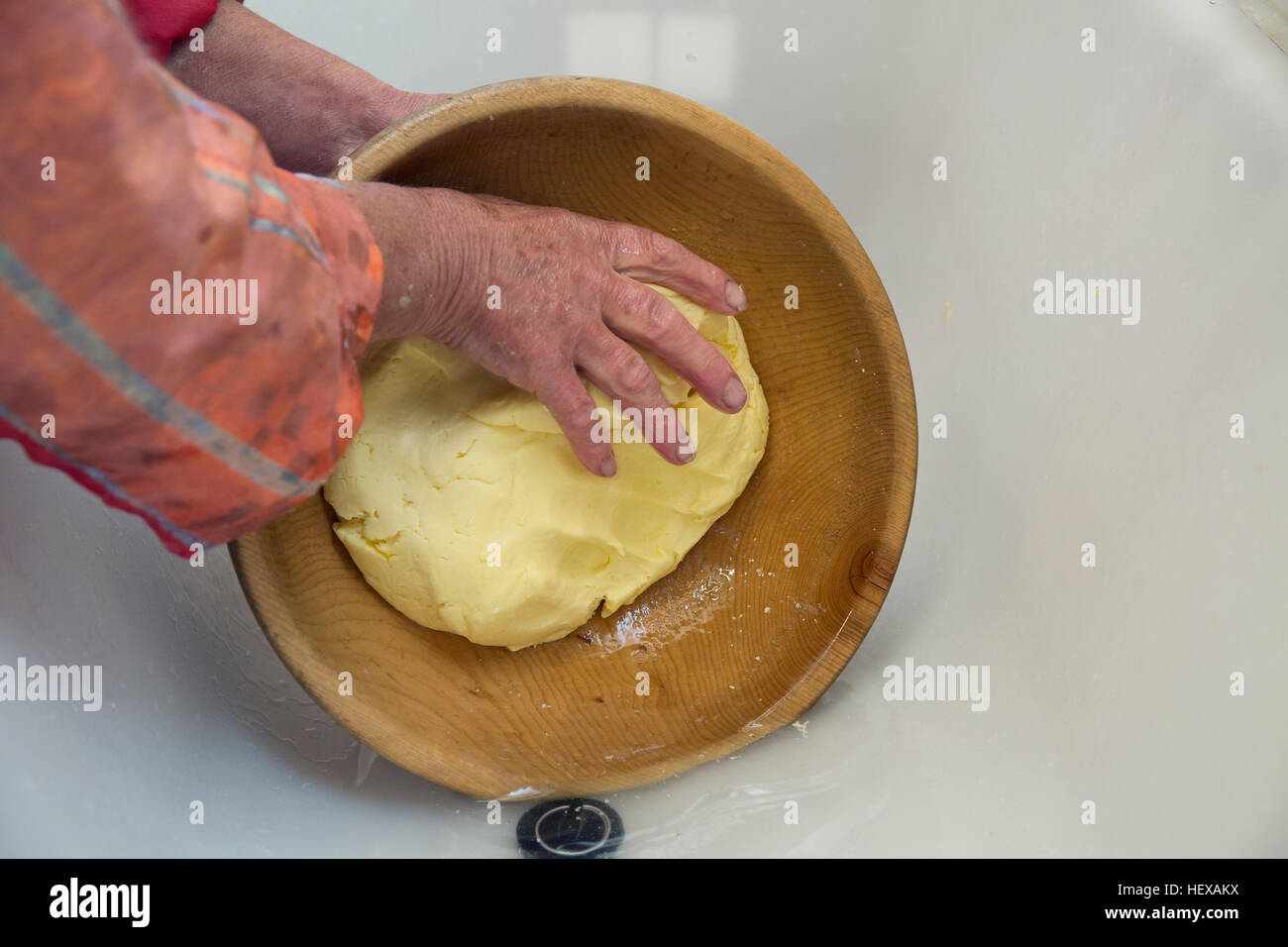 Hands of female dairy farmer shaping butter in bowl, Sattelbergalm ...