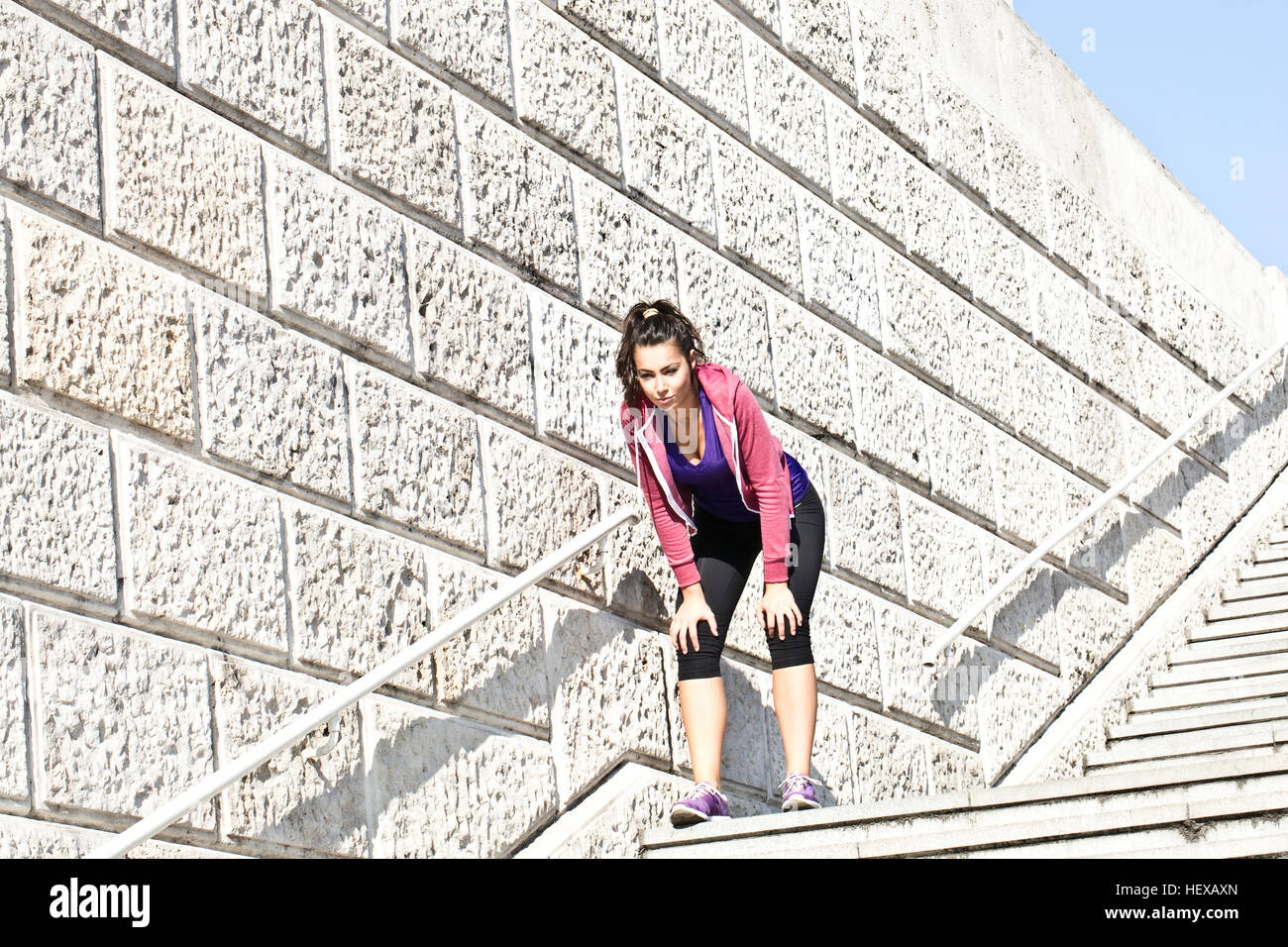 Young female runner taking a break on urban stairway Stock Photo - Alamy