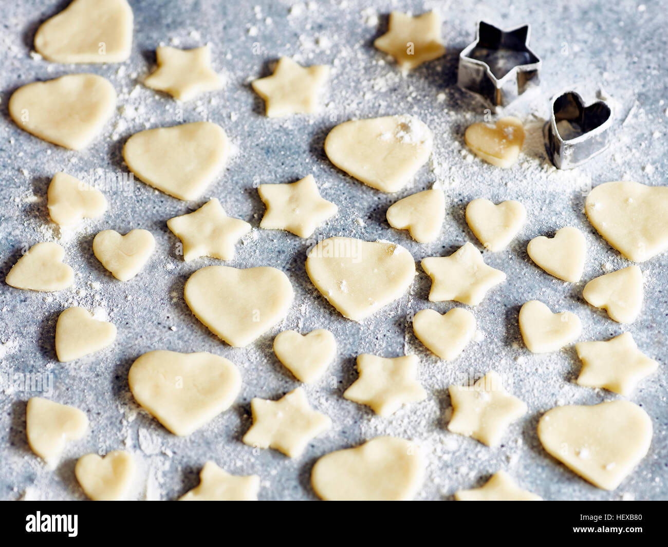 Heart and star shapes cookies with cookie cutters Stock Photo - Alamy
