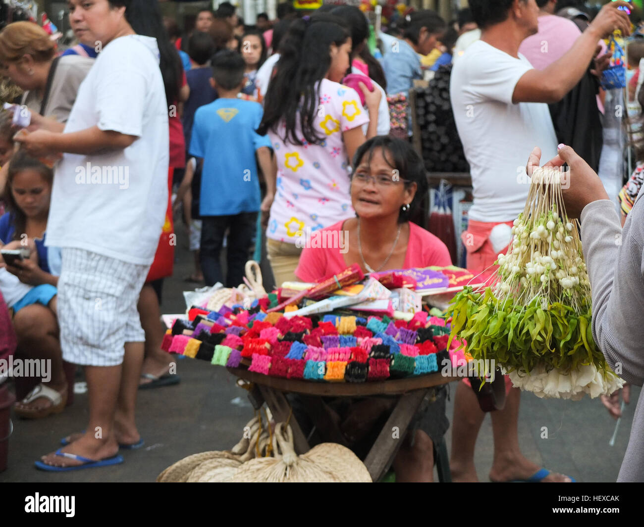 Manila, Philippines. 23rd Dec, 2016. A woman vendor busy selling ...