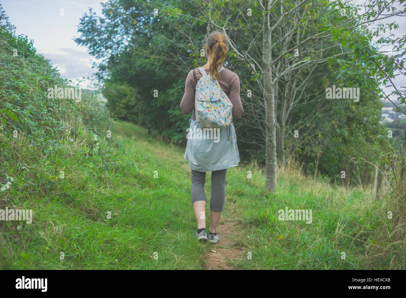 A young woman is walking in the countryside Stock Photo - Alamy