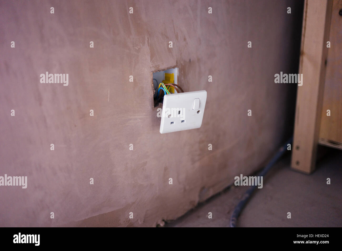 A plug socket and wires in a freshly plastered wall Stock Photo - Alamy