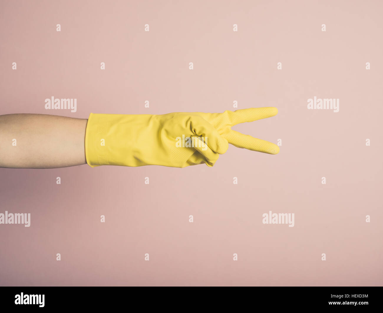 A female hand wearing a rubber glove is showing two fingers Stock Photo ...