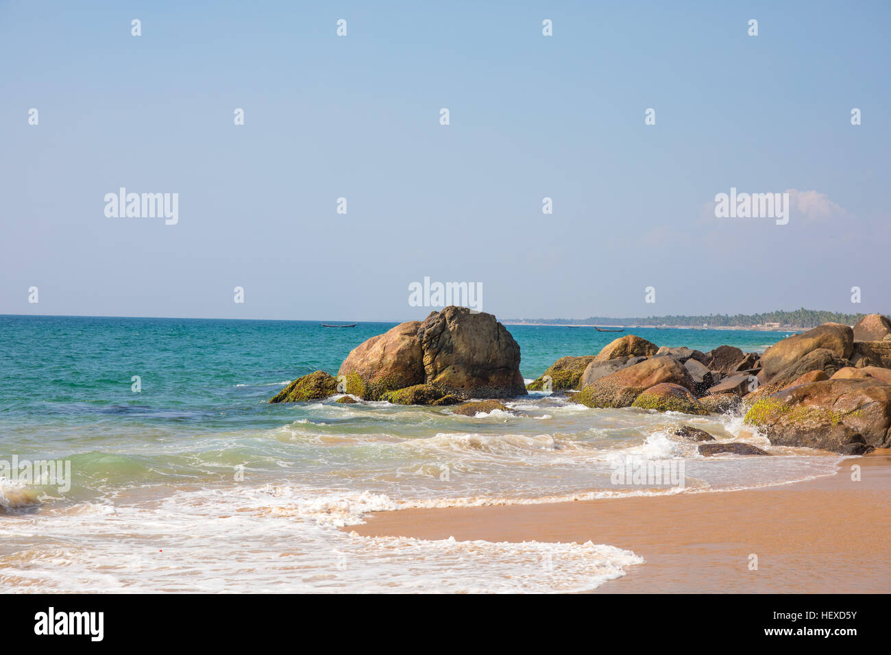 Rocks in the sea at the beach of Kerala, India Stock Photo - Alamy