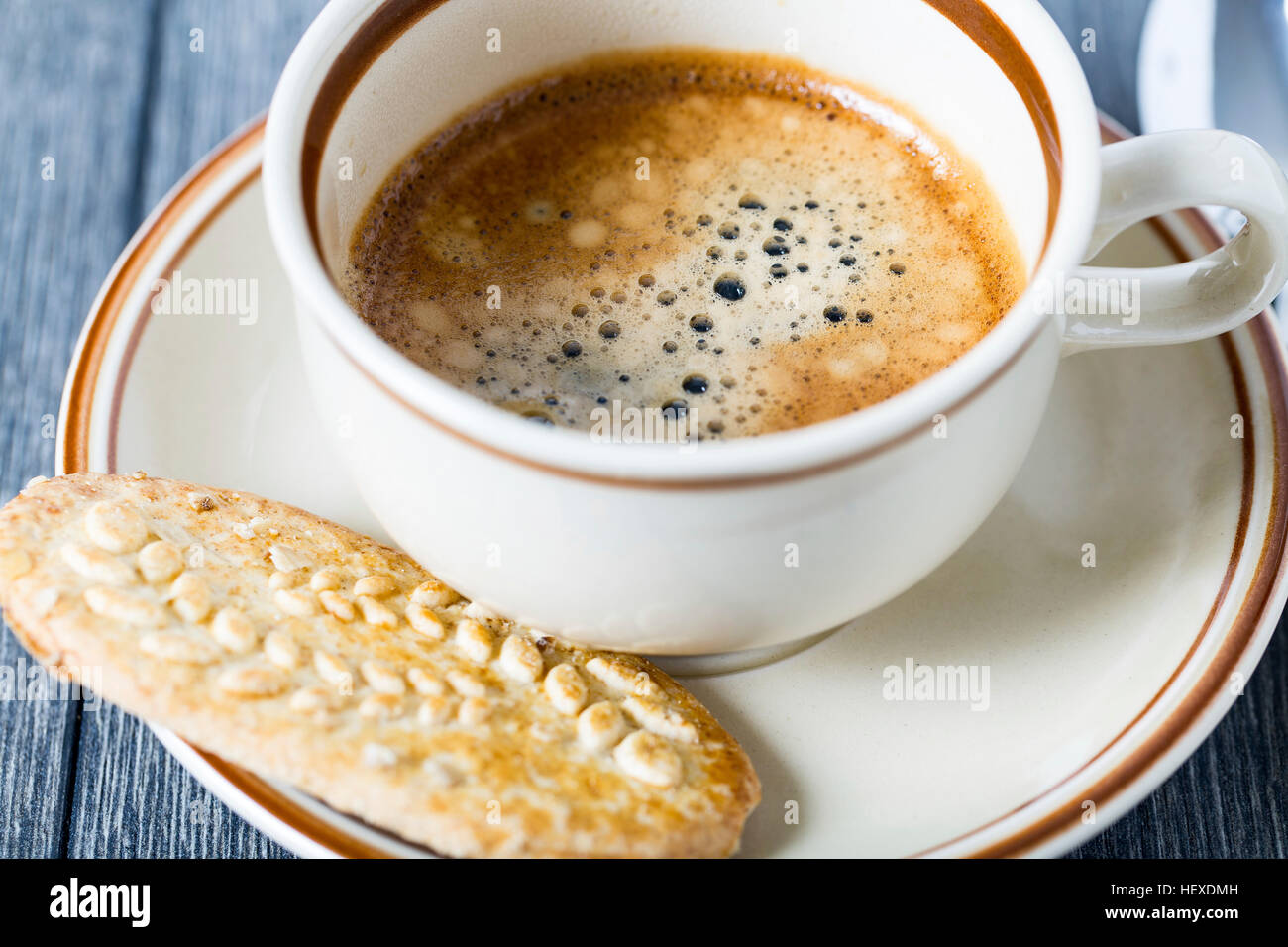 Espresso in coffee cup with biscuit Stock Photo - Alamy