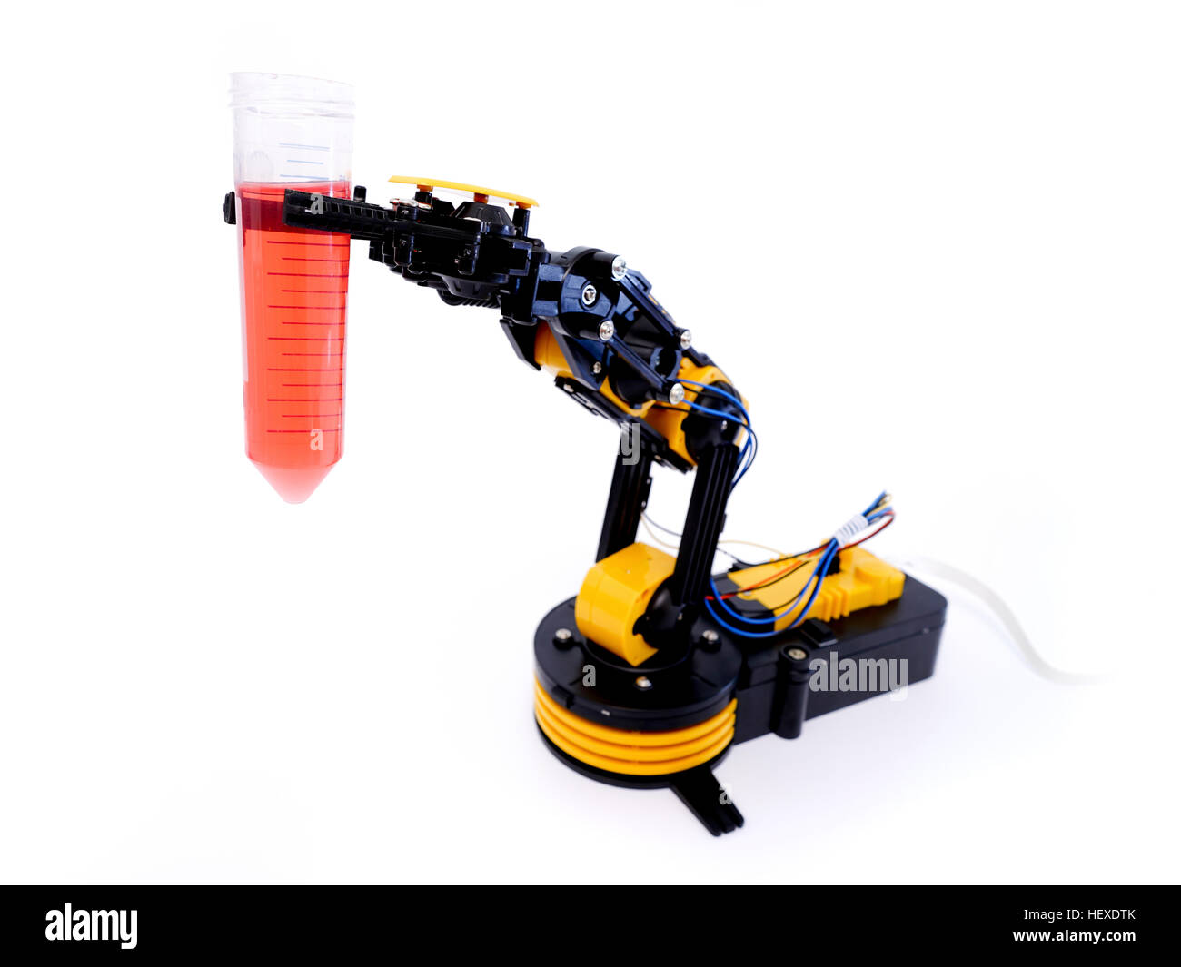 Robotic arm holding beaker against a white background Stock Photo - Alamy