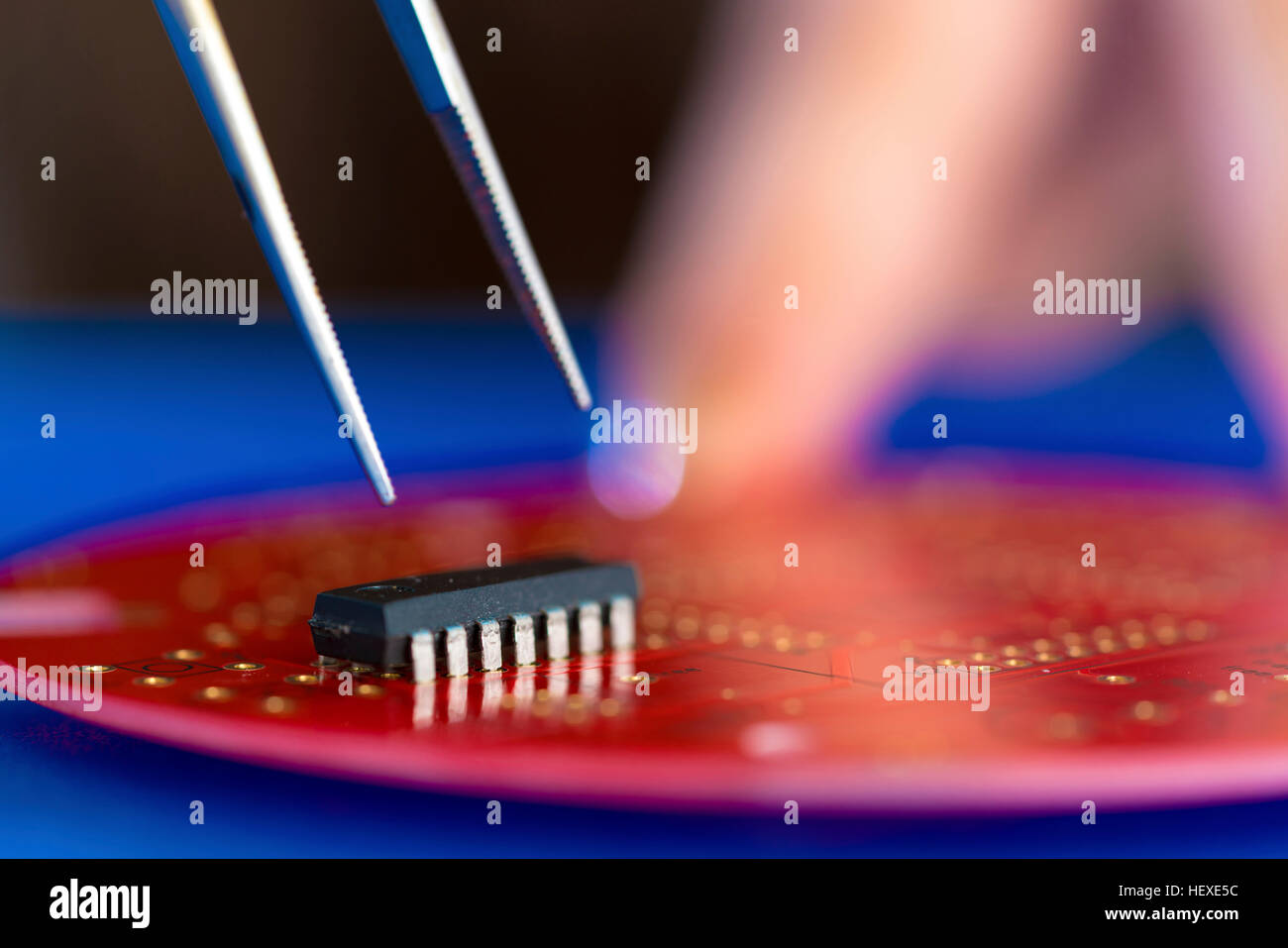 Installing an integrated circuit onto a circuit board Stock Photo - Alamy