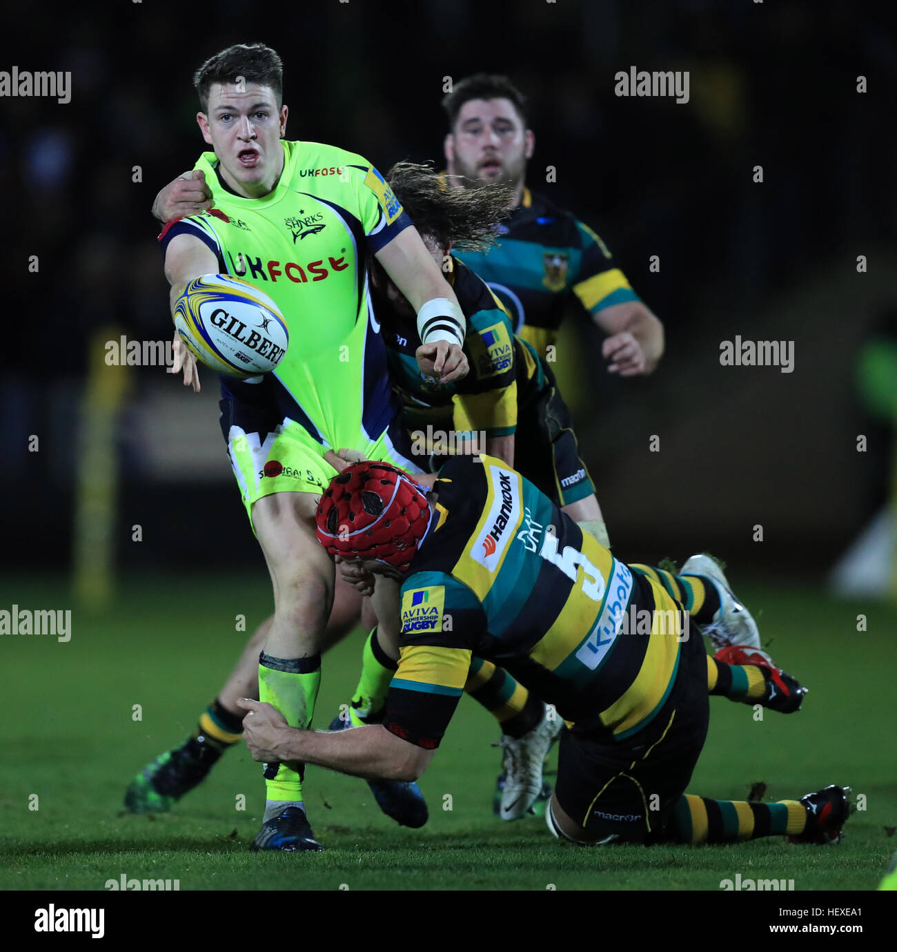 Sale Sharks' Sam James is held by Northampton Saints' Christian Day and ...