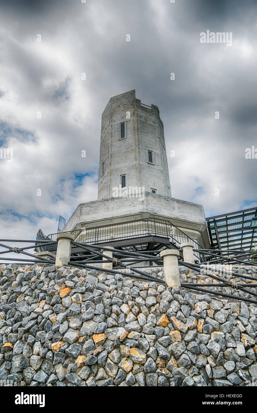 Rock wall and stairs at beautiful restored white castle with red tiles ...