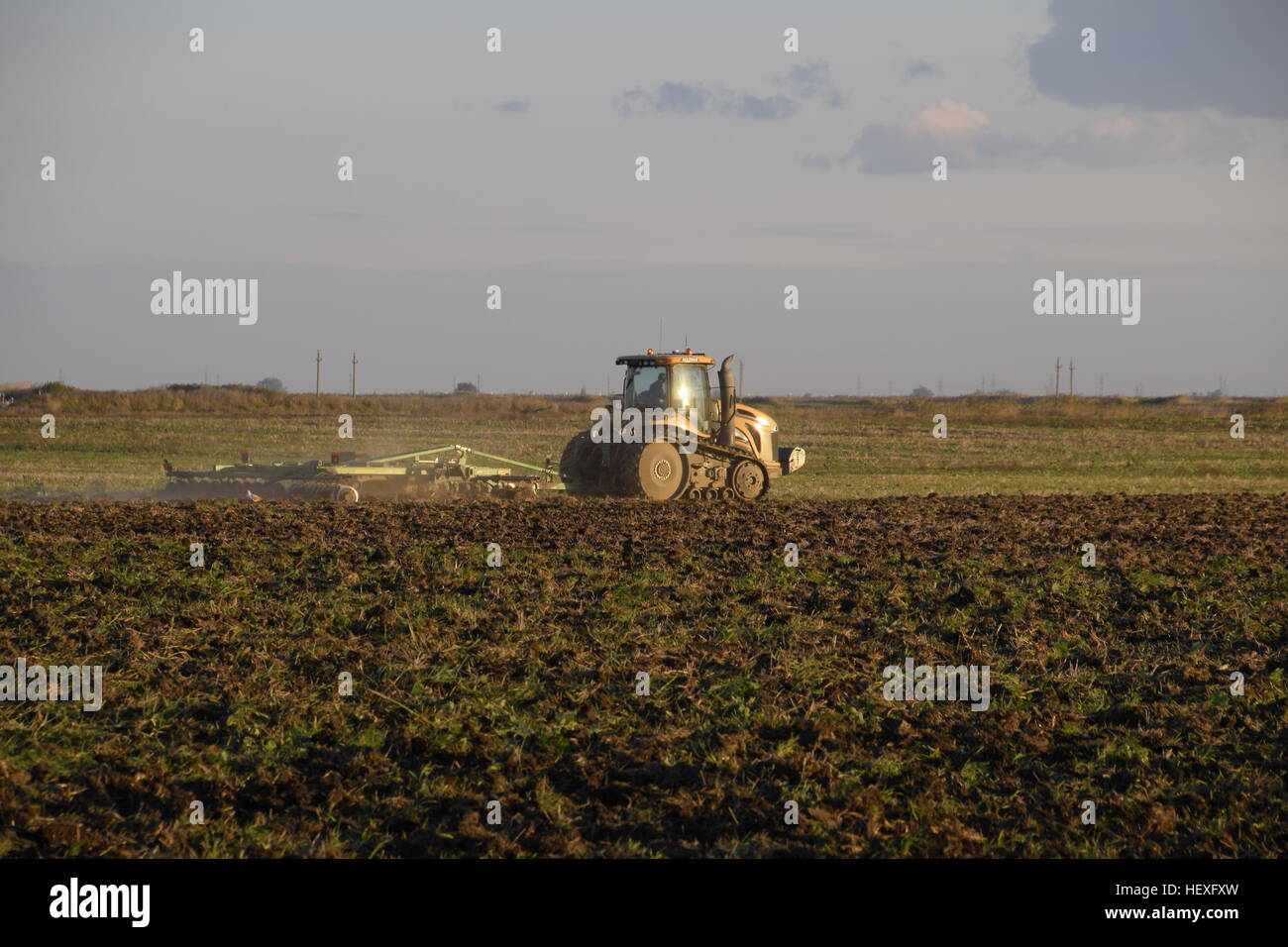 Tractor plowing plow the field. Tilling the soil in the fall after ...