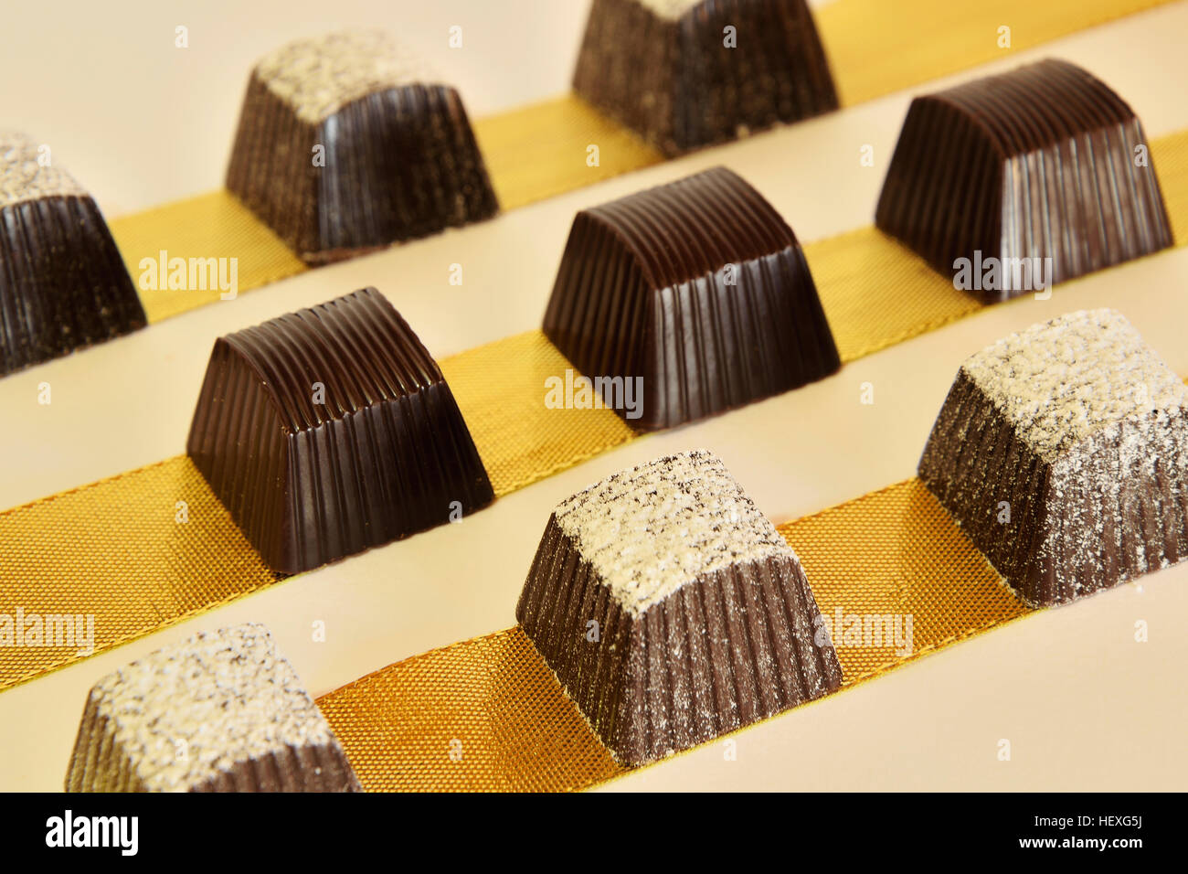 Chocolates in Golden row Stock Photo - Alamy