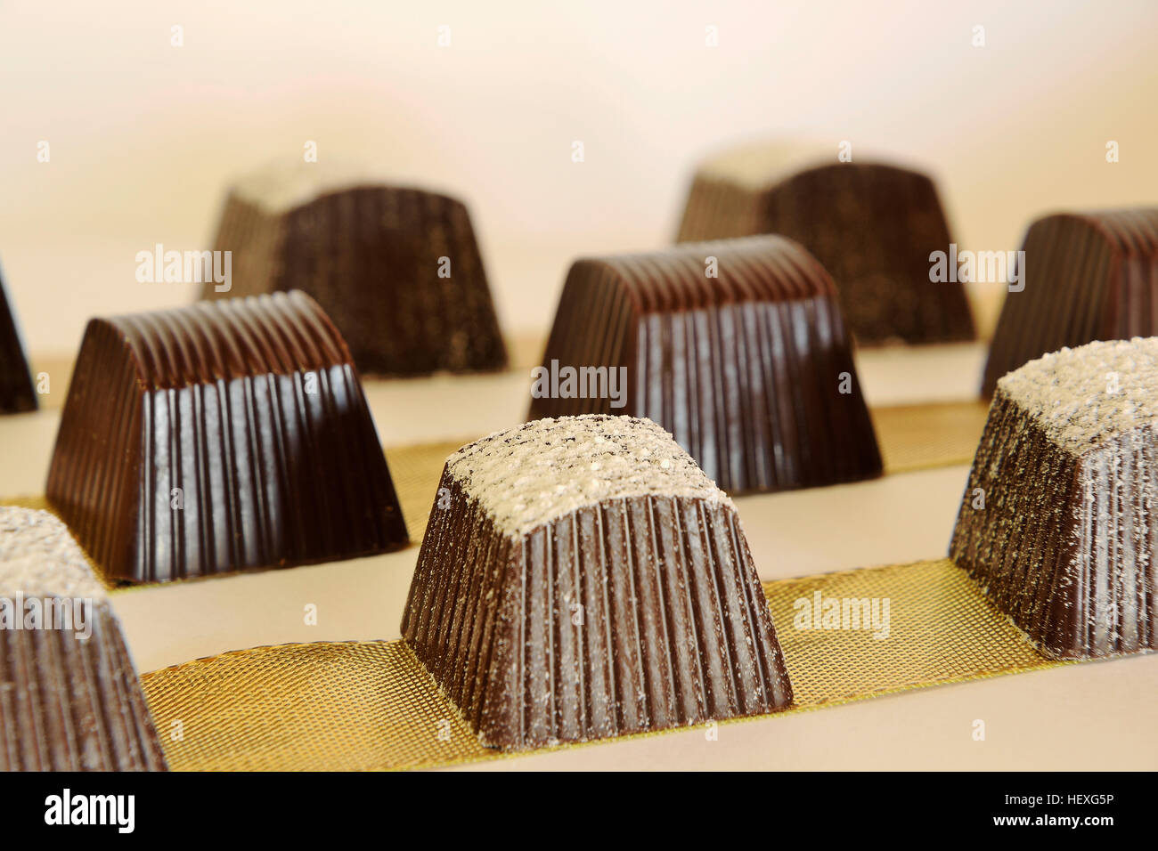 Chocolates in Golden row Stock Photo - Alamy