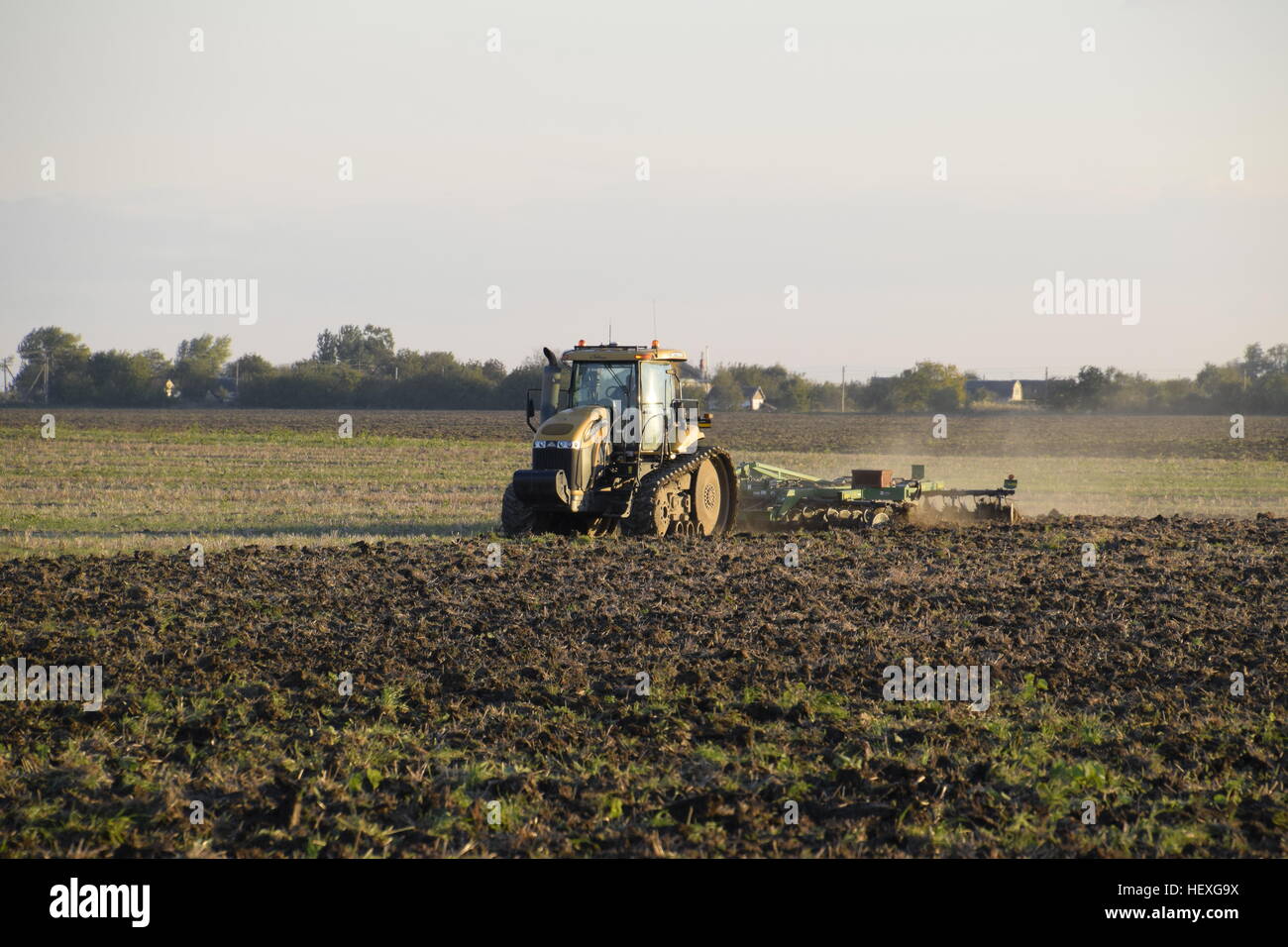 Tractor plowing plow the field. Tilling the soil in the fall after ...