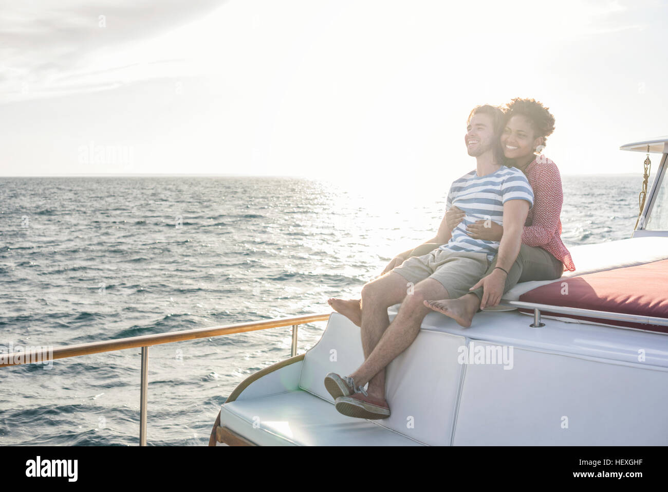 Happy young couple on a boat trip Stock Photo - Alamy