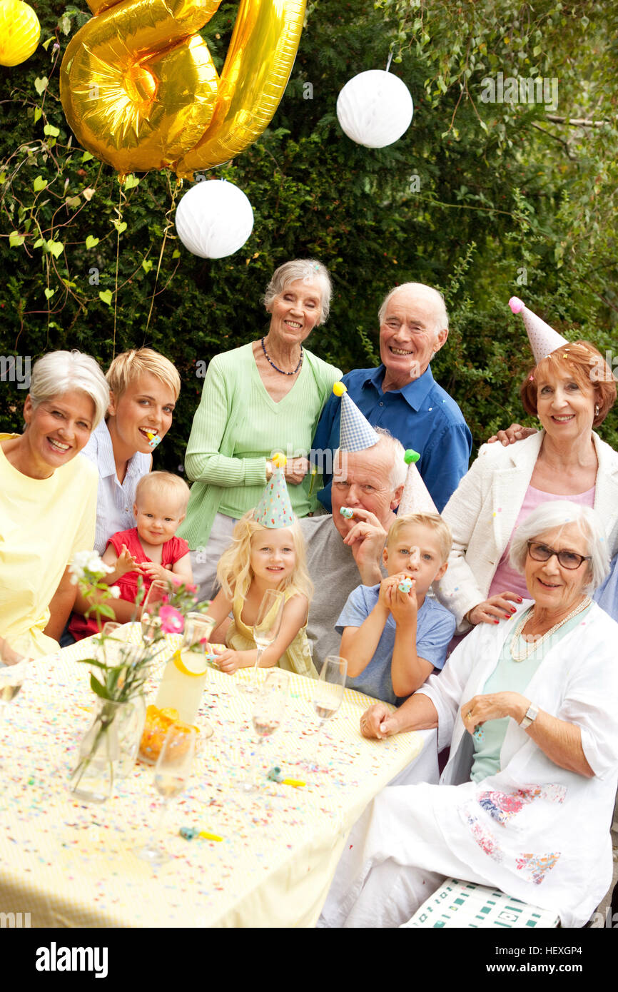 Extended family and friends having birthday party in garden Stock Photo ...