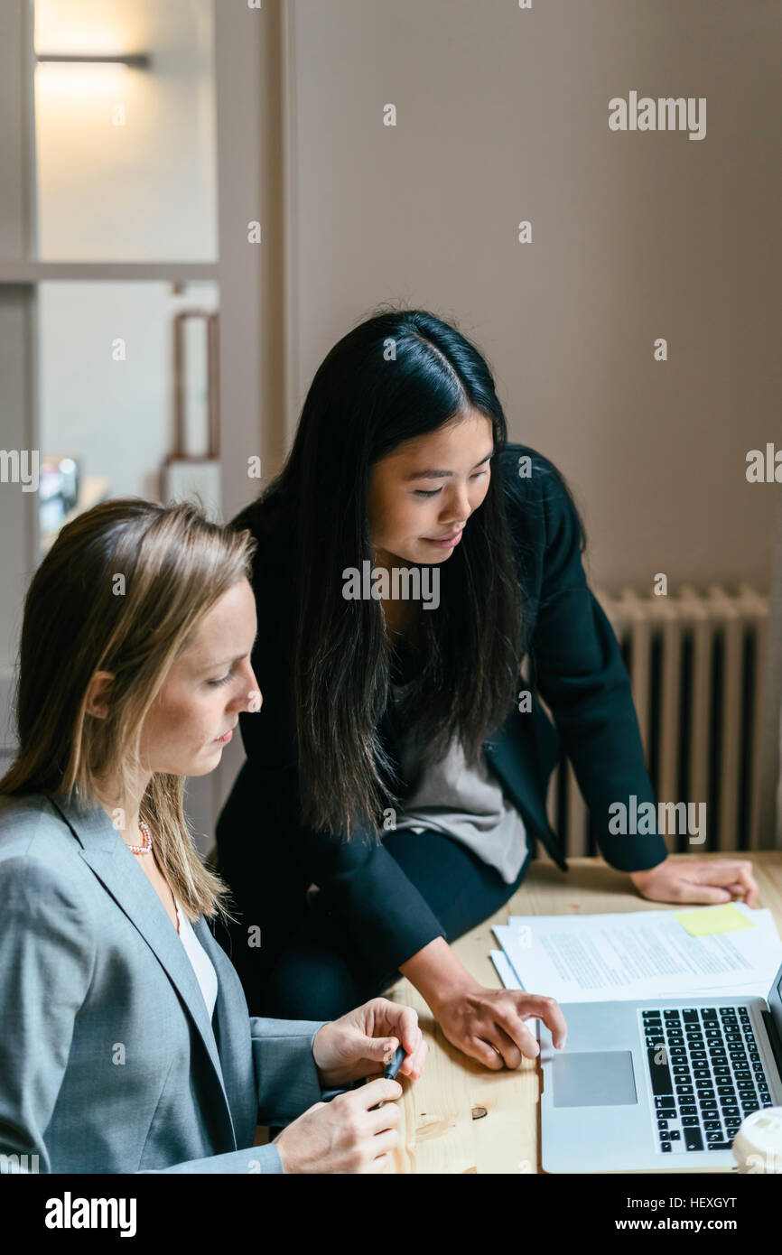Two business women working together in office Stock Photo - Alamy