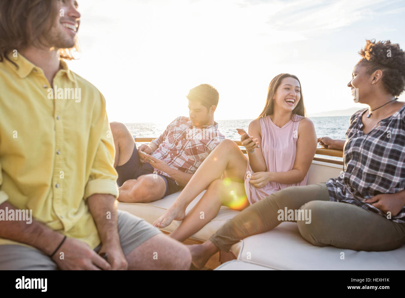 Happy friends hanging out on a boat trip Stock Photo - Alamy