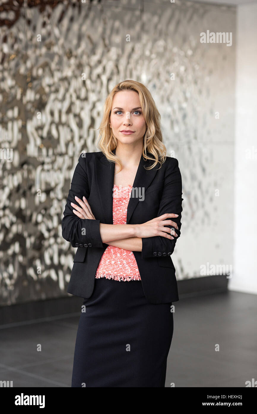 Portrait of confident businesswoman in front of rippled wall Stock ...
