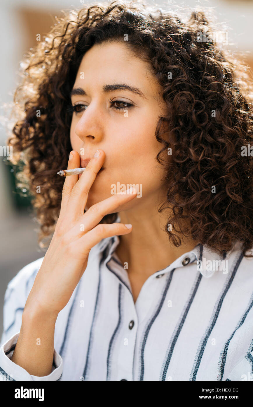Portrait of smoking young woman Stock Photo - Alamy