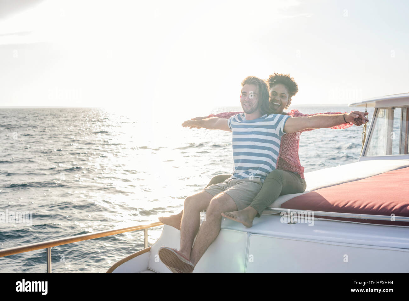 Happy young couple on a boat trip Stock Photo - Alamy