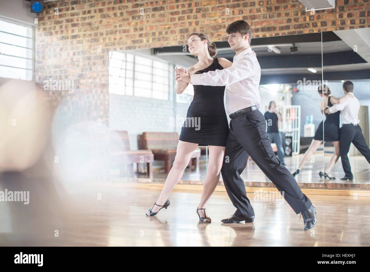Couple dancing salsa in studio Stock Photo - Alamy