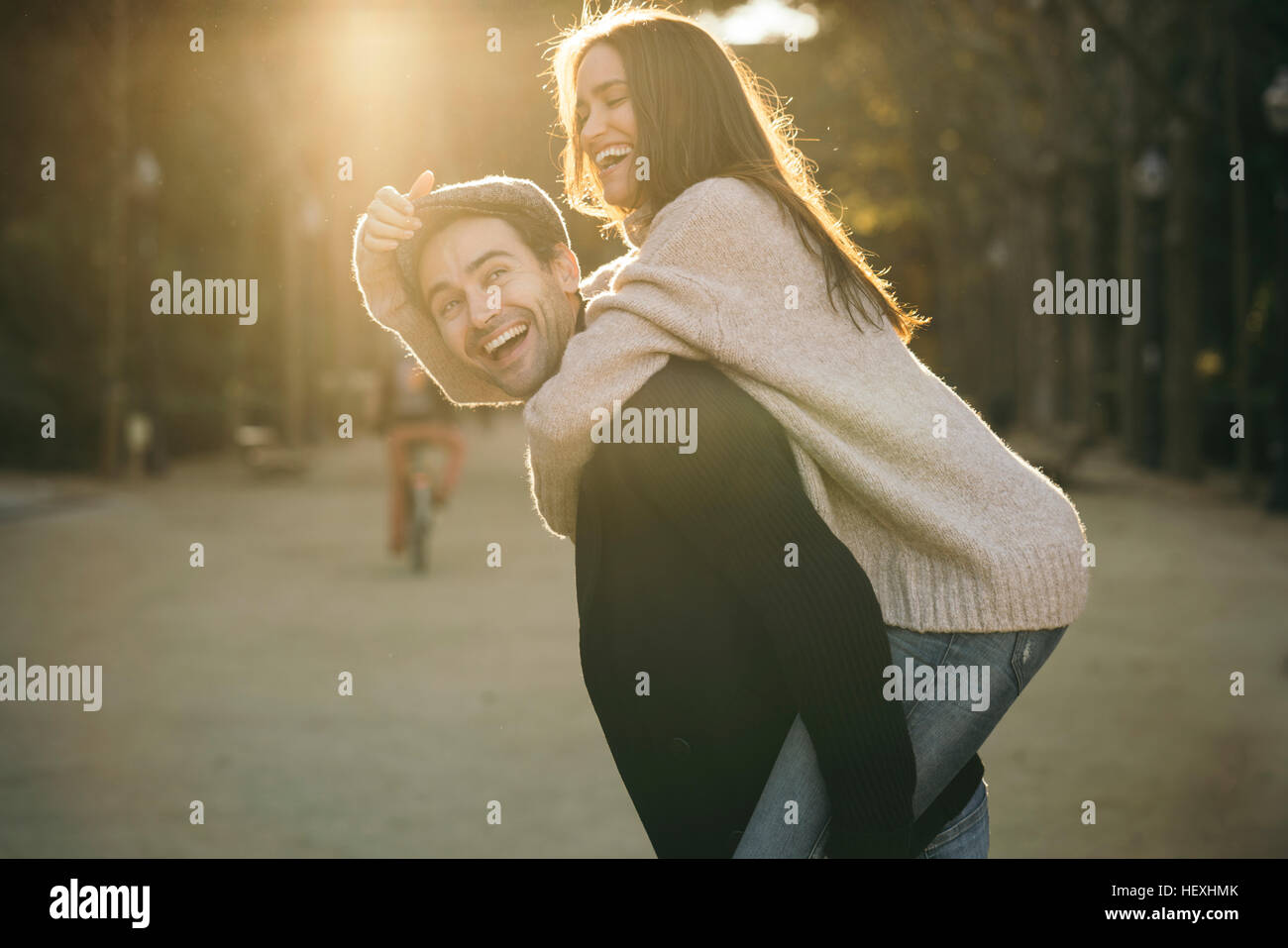 Couple having fun together in a park at evening twilight Stock Photo ...