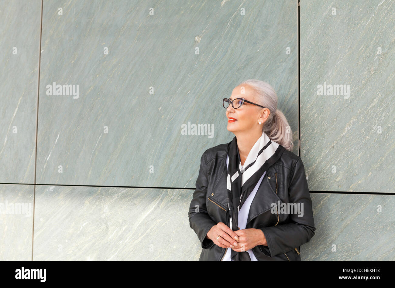 Smiling mature woman looking at distance Stock Photo - Alamy
