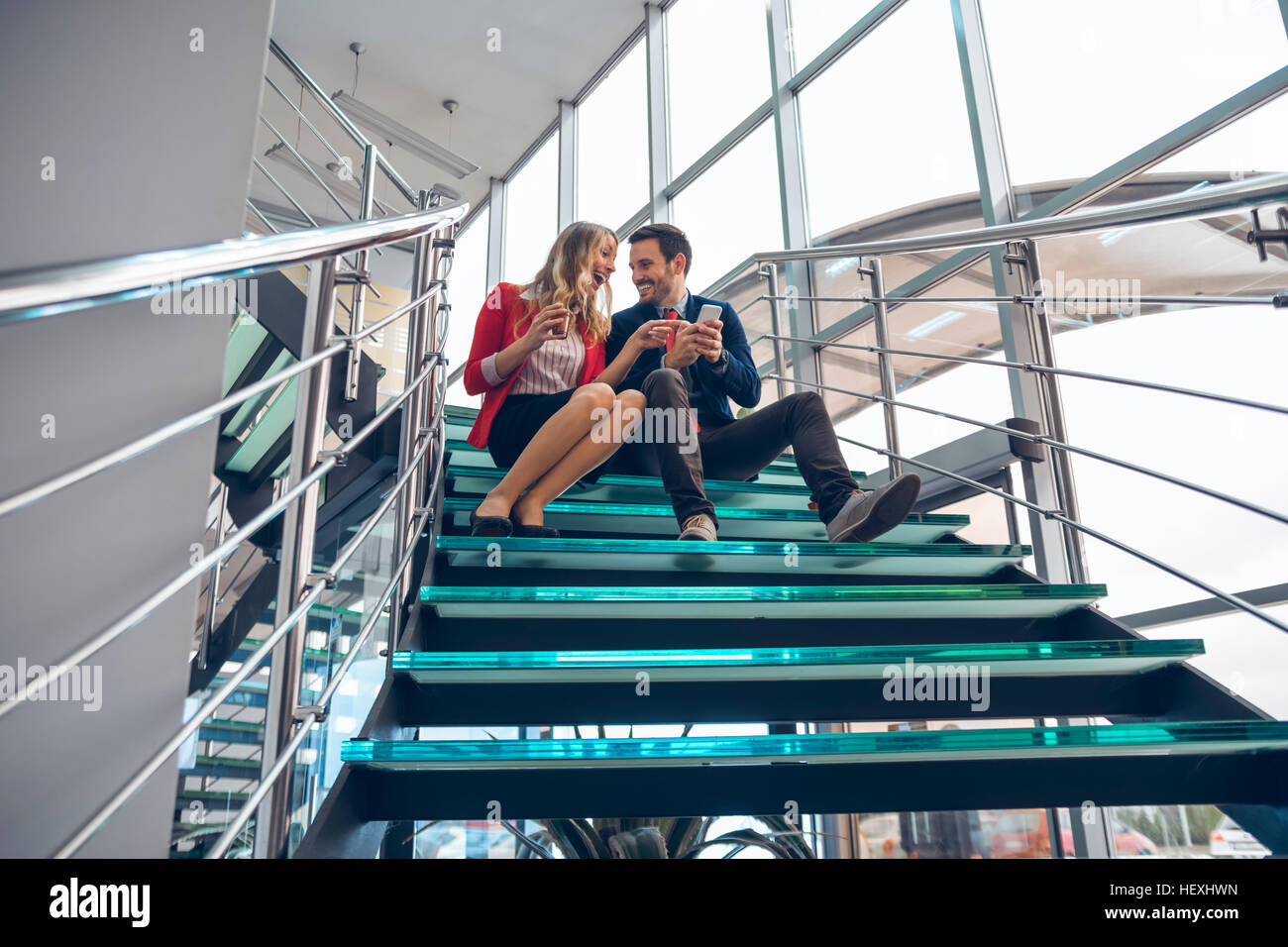 Businessman Businesswoman On Stairs Cell High Resolution Stock ...