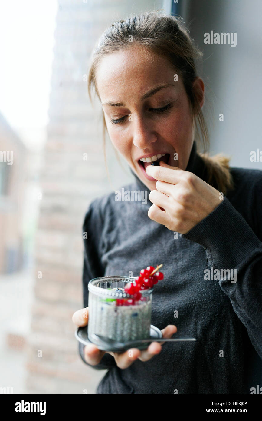 Woman eating fruit pudding hi-res stock photography and images - Alamy