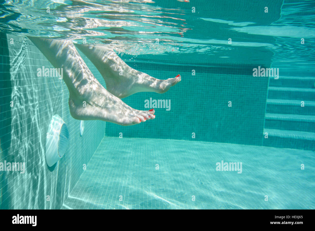 Female feet in swimming pool Stock Photo - Alamy
