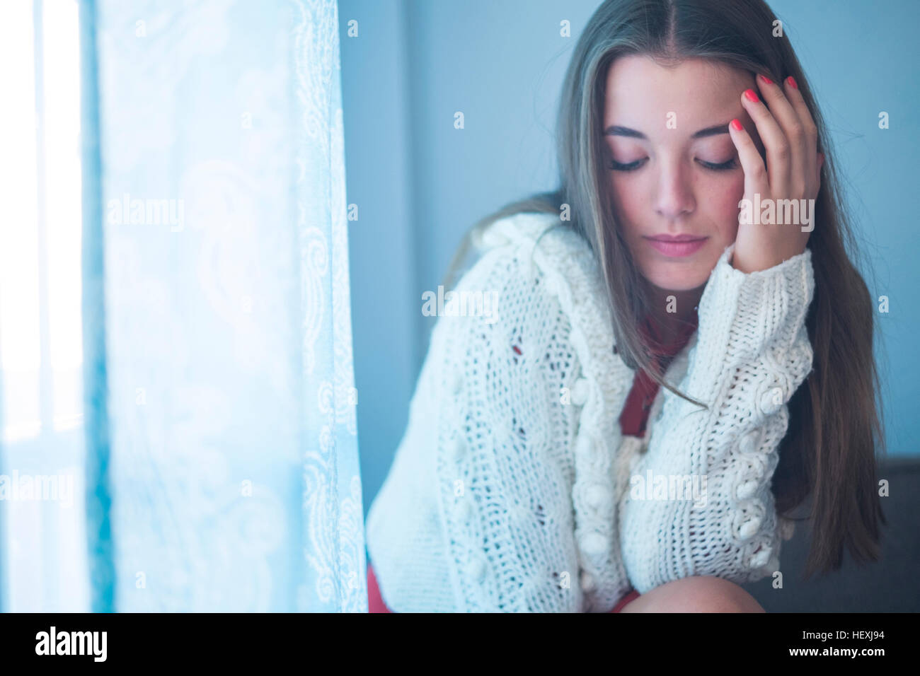Portrait of young woman looking down Stock Photo - Alamy