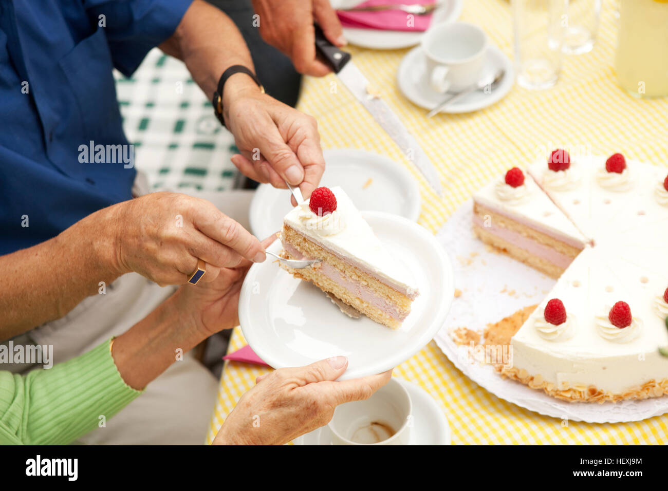 Hands putting cream cake on plates Stock Photo - Alamy