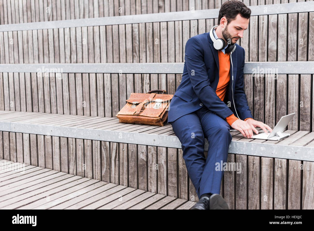 USA, New York City, Businessman sitting on stairs using digital tablet ... USA, New York City, Businessman sitting on stairs using digital tablet ...