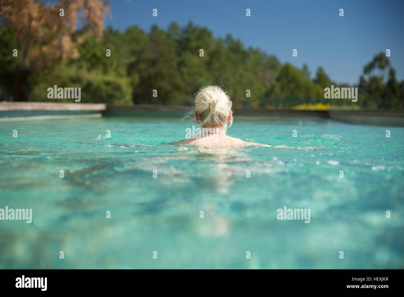 Woman swimming in pool, rear view Stock Photo - Alamy