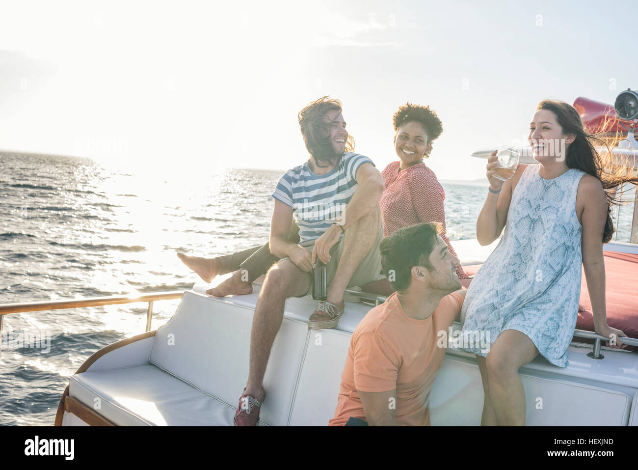 Happy friends on a boat trip having a drink Stock Photo - Alamy