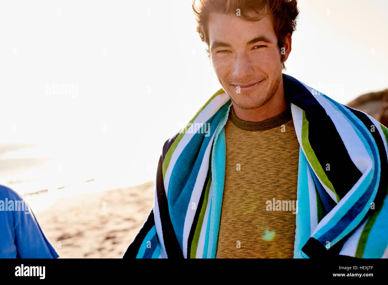 Portrait of smiling young man on the beach Stock Photo - Alamy
