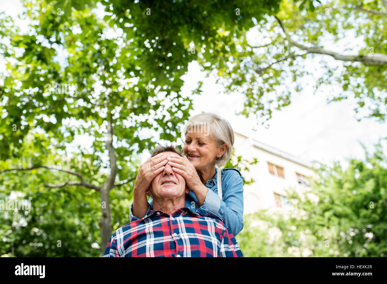 Woman covering husbands eyes hi-res stock photography and images - Alamy