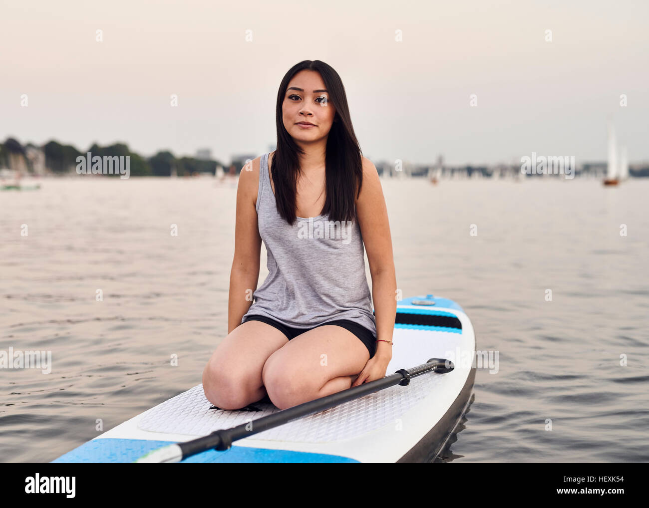 Asian woman on paddleboard hi-res stock photography and images - Alamy