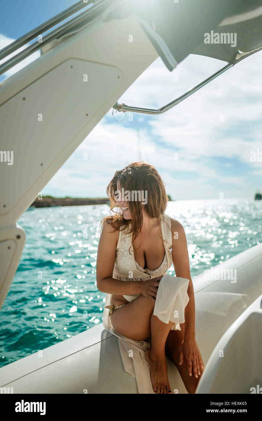 Woman sitting on a motor boat Stock Photo - Alamy
