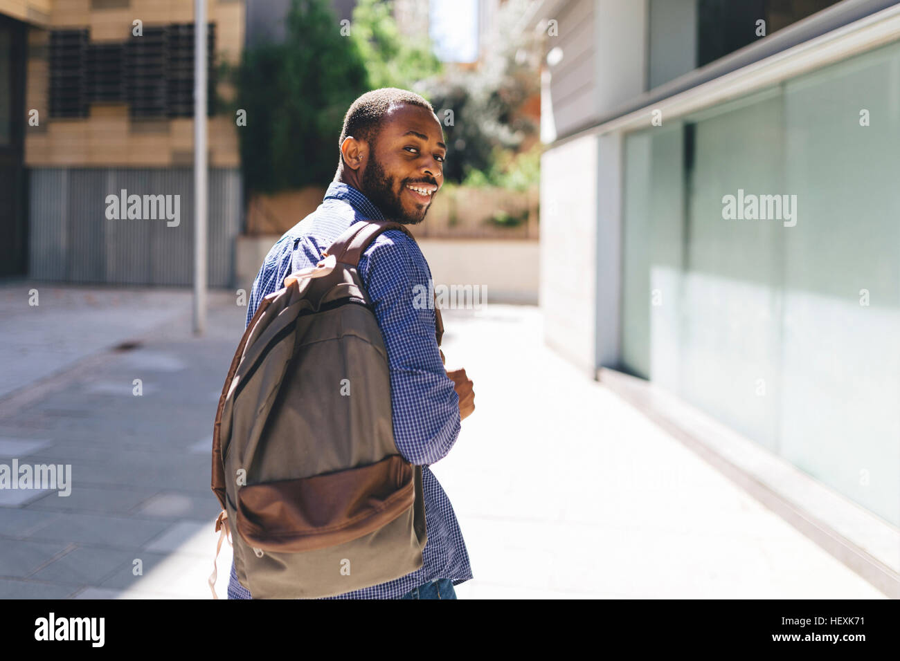 Smiling man with backpack Stock Photo - Alamy