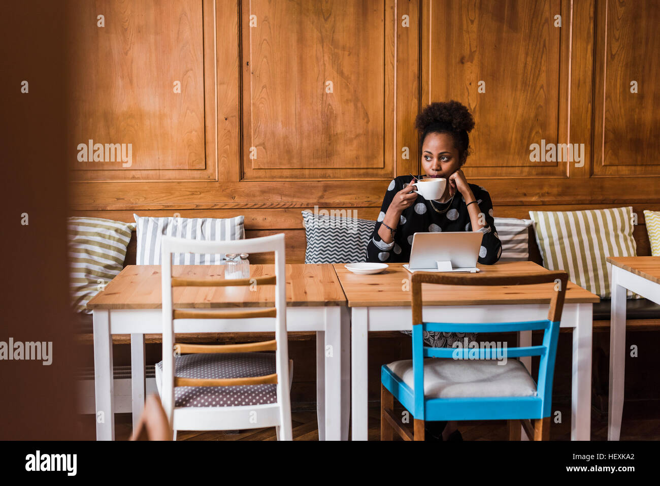 Young woman with tablet drinking coffee in a cafe Stock Photo - Alamy